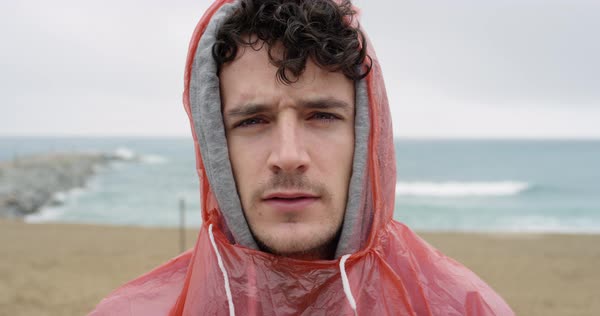 Close-up portrait of of man serious face wet hair blowing in wind in ...