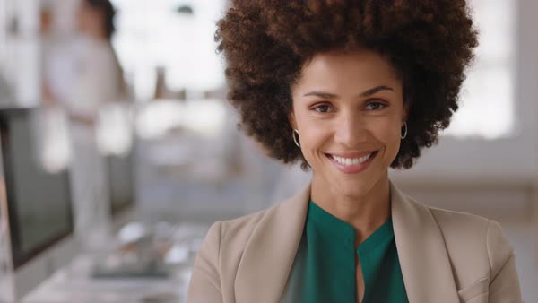 Portrait mixed race business woman with afro smiling confident ...
