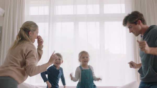 Happy family dancing at home having fun dance celebrating together ...