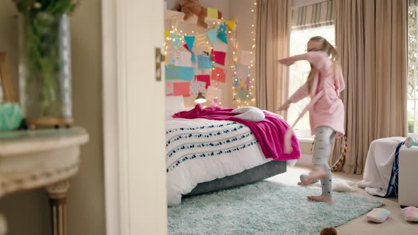Happy little girl dancing in bedroom practicing ballet dance moves ...