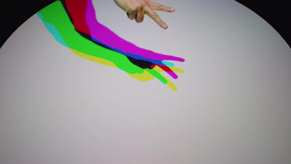 Colorful hand making peace sign on white background in multicolor light ...