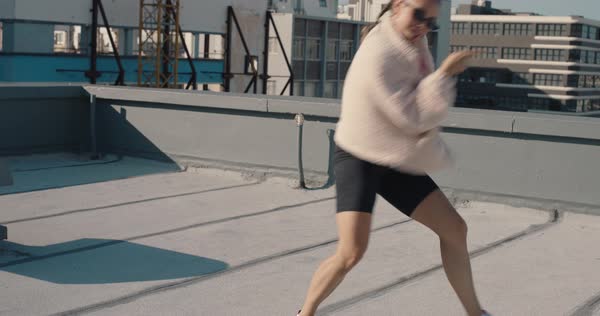 Woman dancing on roof top girl performing hip hop dance style having ...