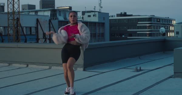 Woman dancing on roof top girl performing hip hop dance style having ...