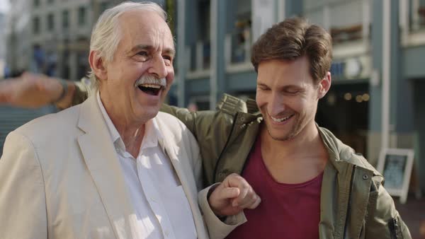 Family reunion portrait of elderly father and adult son smiling happy ...