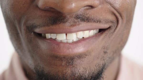 Close up man mouth smiling - 4K Royalty-free Stock Video Footage | Dissolve