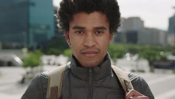 Portrait of handsome young mixed race man unhappy worried looking at ...