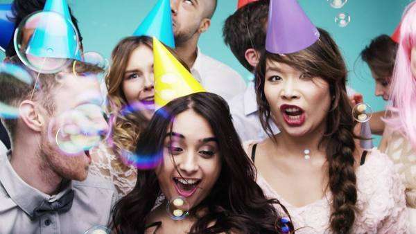 Group of happy people dancing with bubbles slow motion party photo ...