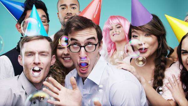 Group of happy people dancing with bubbles slow motion party photo ...