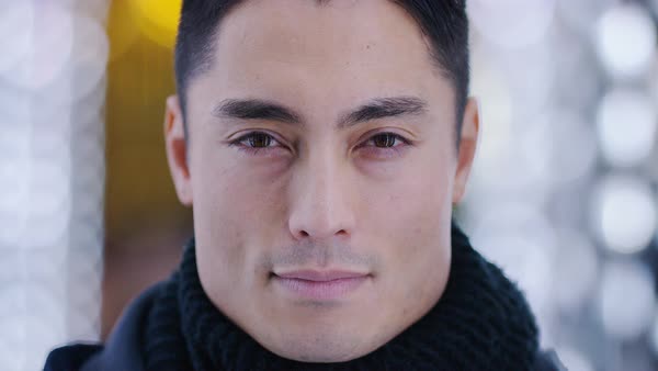 Portrait of handsome Japanese male looking to camera, surrounded by ...