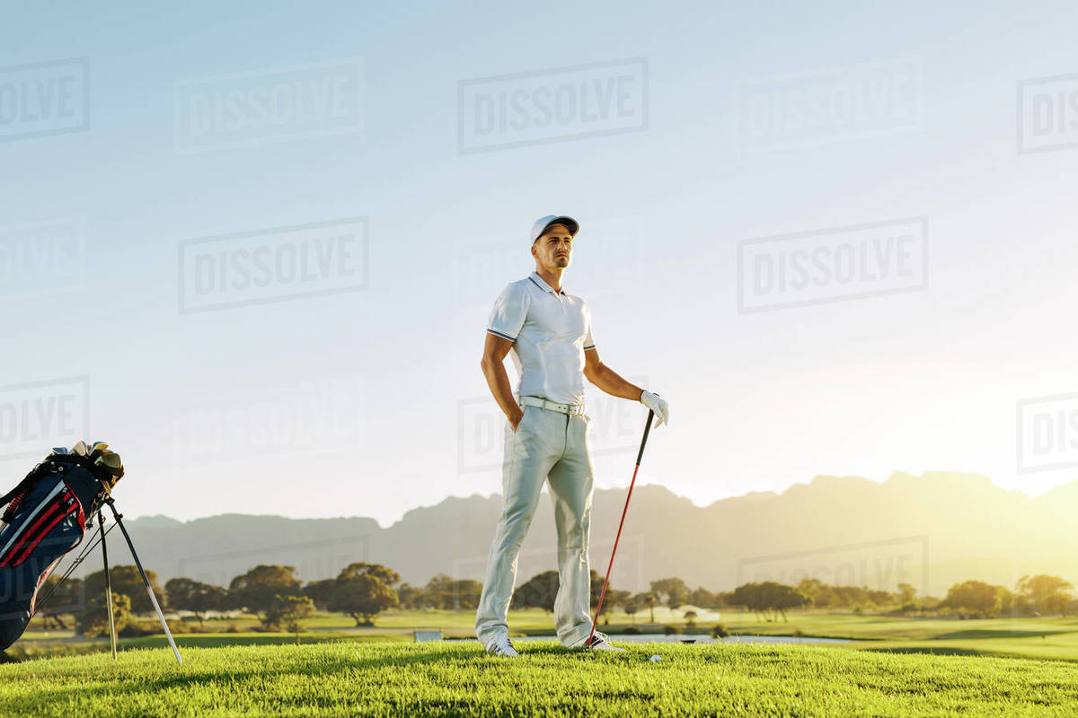 Full length of male golfer on golf course waiting to tee off. Man ...