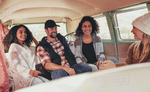 Multiethnic friends on roadtrip travelling together in a van. Group of ...