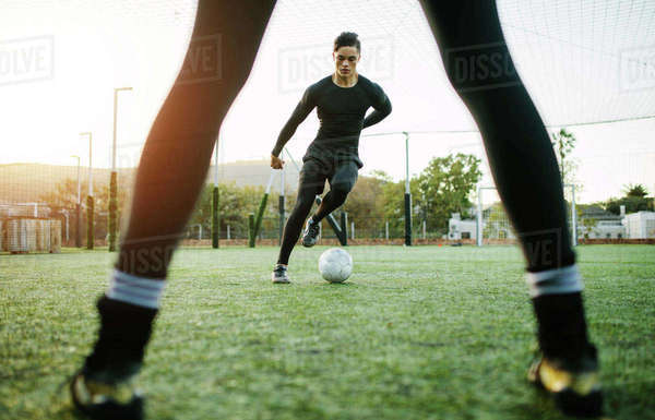 Soccer players during practice on football ground. Young footballer ...