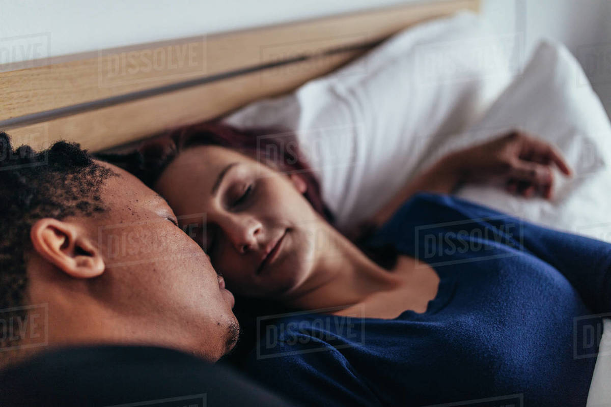 Close up of couple sleeping on bed. Man and woman sleeping peacefully ...