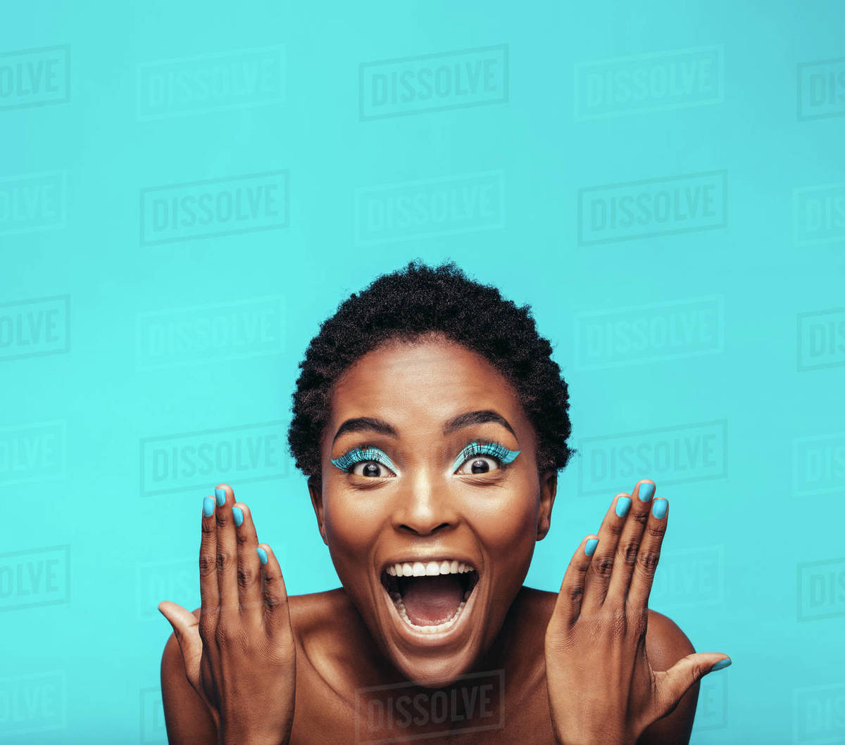 Excited young woman with vibrant eye shadow and nail paint. Female ...