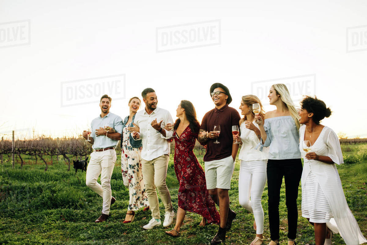 Group of friends chilling outside taking a walk together at vineyard ...