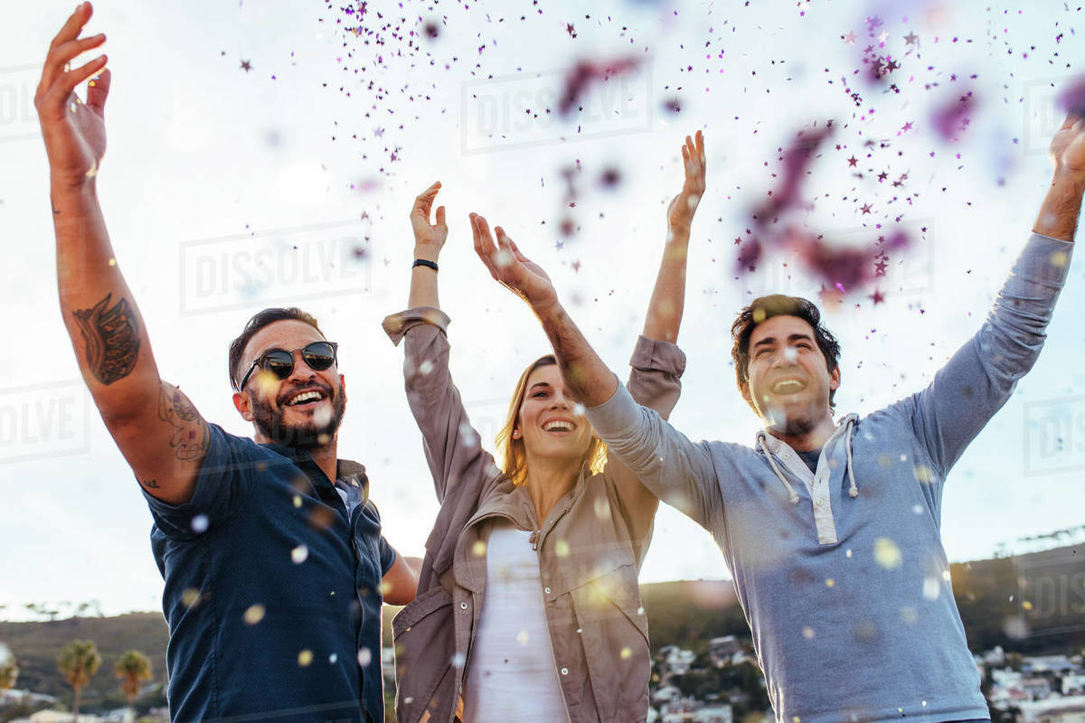 Group of millennial hanging out together on rooftop party. Young men ...