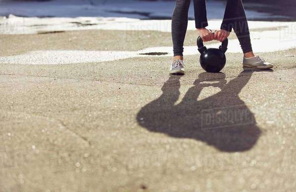 Shadow of a fitness crossfit woman lifting a kettlebell - Royalty-free ...