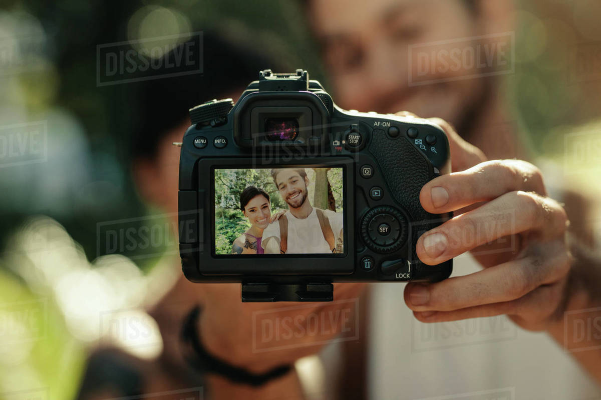 Close up of a camera screen showing a tourist couple taking selfie ...