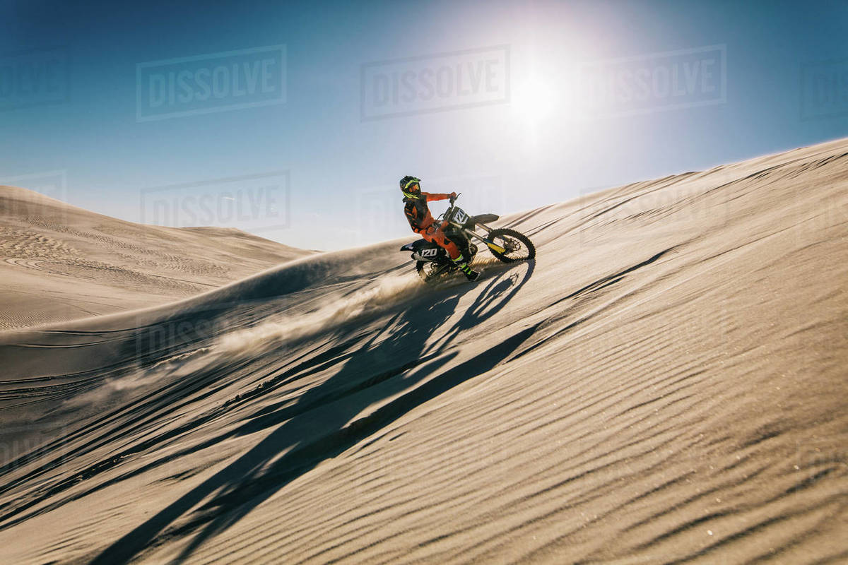 Professional motocross biker on his bike during a desert race ...