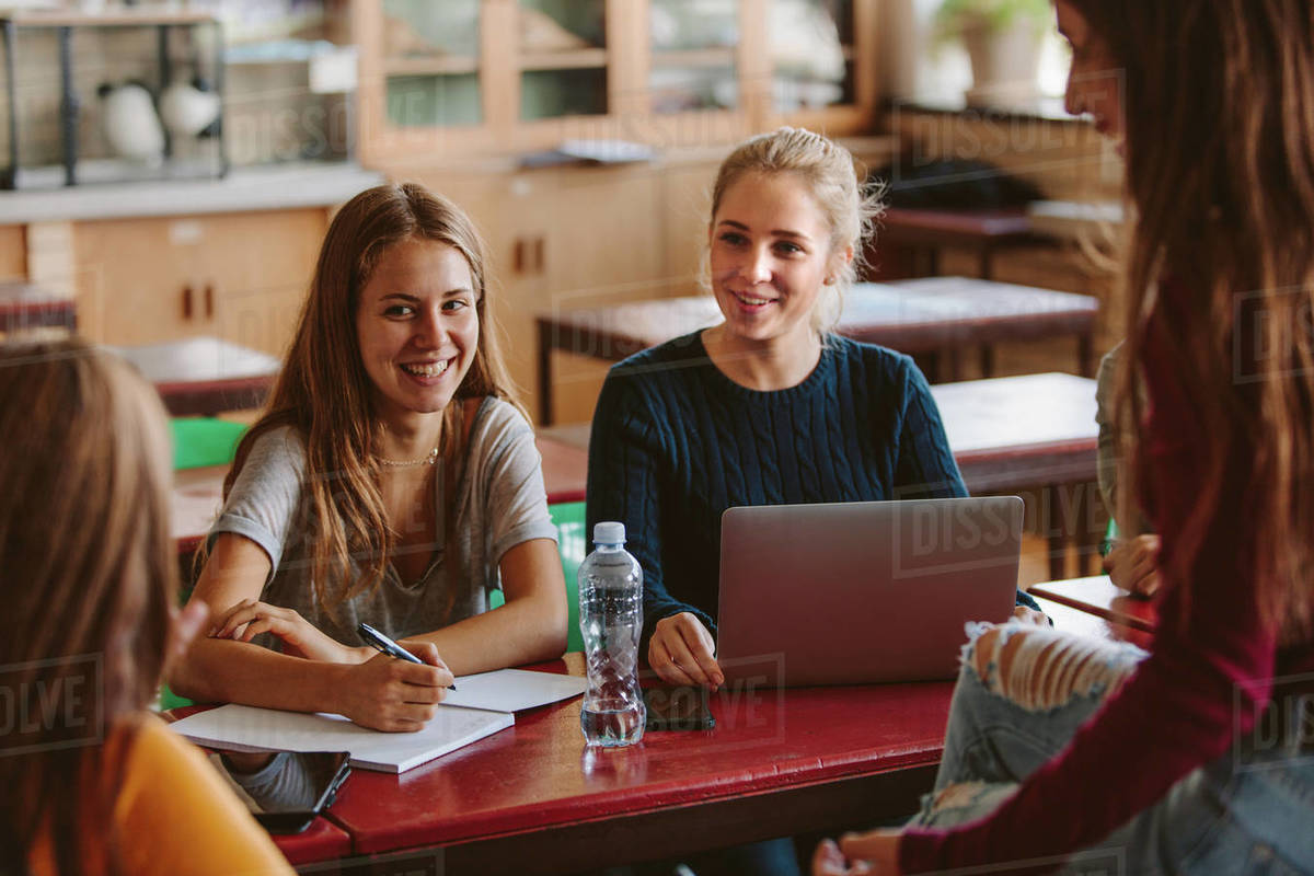 Group of students talking in classroom after the lecture. Female ...