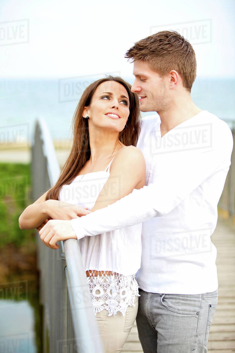 Portrait of a romantic young couple looking at each other while dating ...