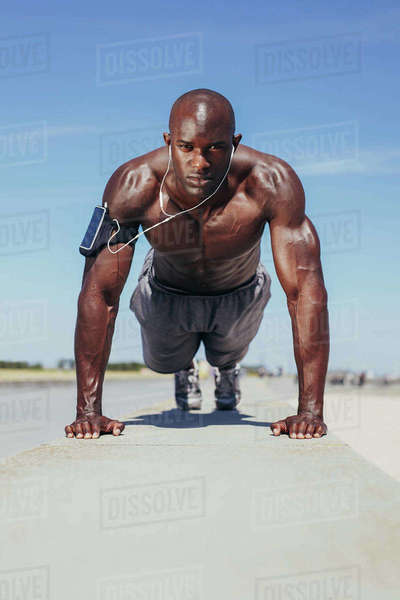 Image of shirtless young man doing push-ups. Muscular young fitness ...