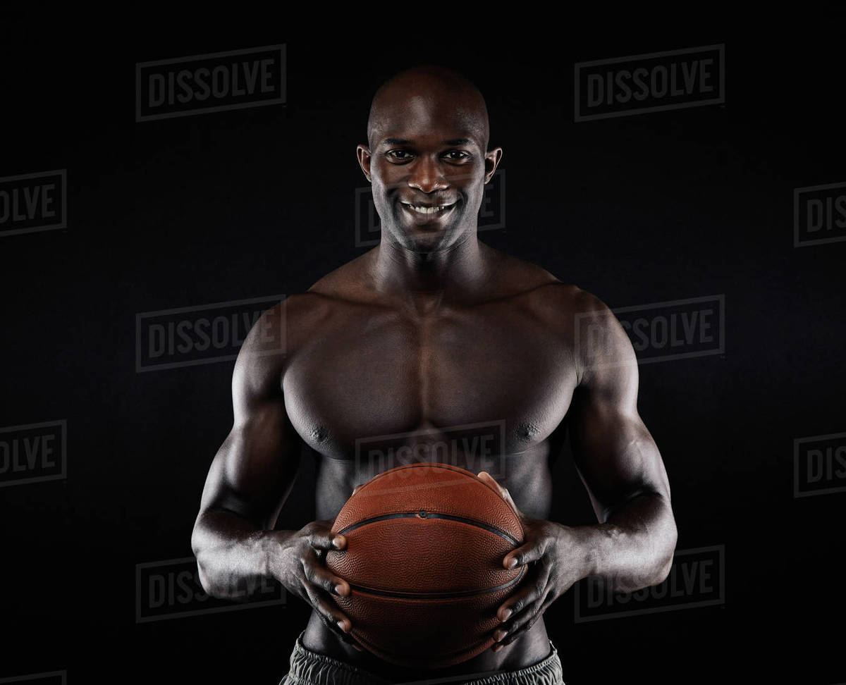 Portrait of happy young muscular man with basketball. Shirtless ...