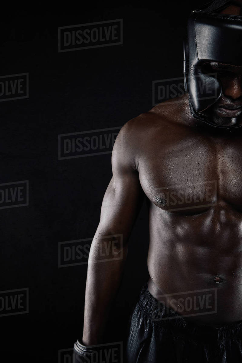 Muscular body of african male boxer against black background with copy ...