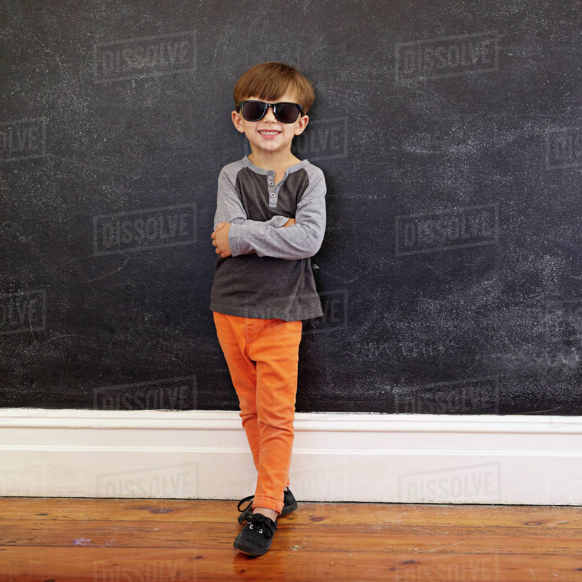 Full length shot of stylish little boy standing in front of the ...