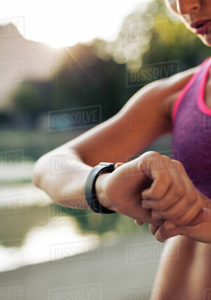 Close up shot of young woman jogger ready to run set and looking at ...