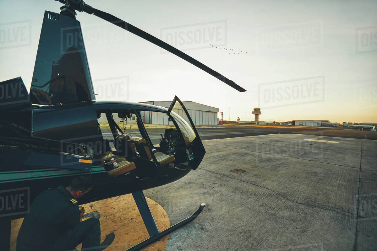 Pilot checking the condition of helicopter before take off. Pilot doing ...