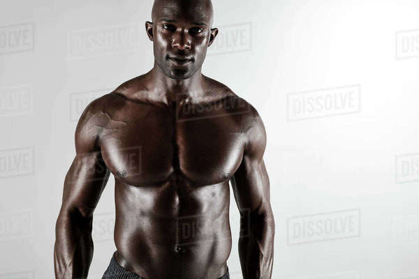 Portrait of masculine young african male model posing shirtless against ...