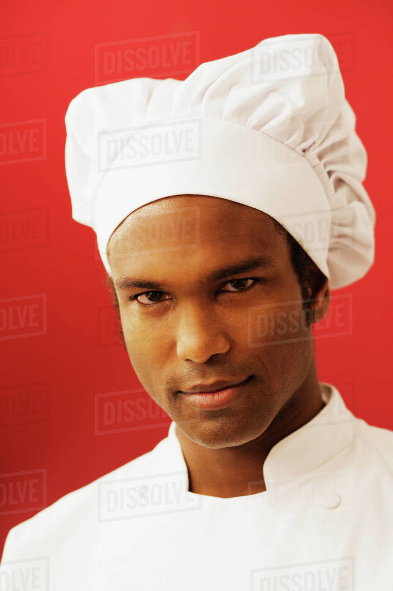 Portrait of male chef wearing hat - Royalty-free Stock Photo | Dissolve