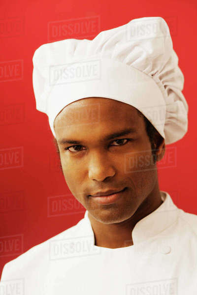Portrait of male chef wearing hat - Royalty-free Stock Photo | Dissolve