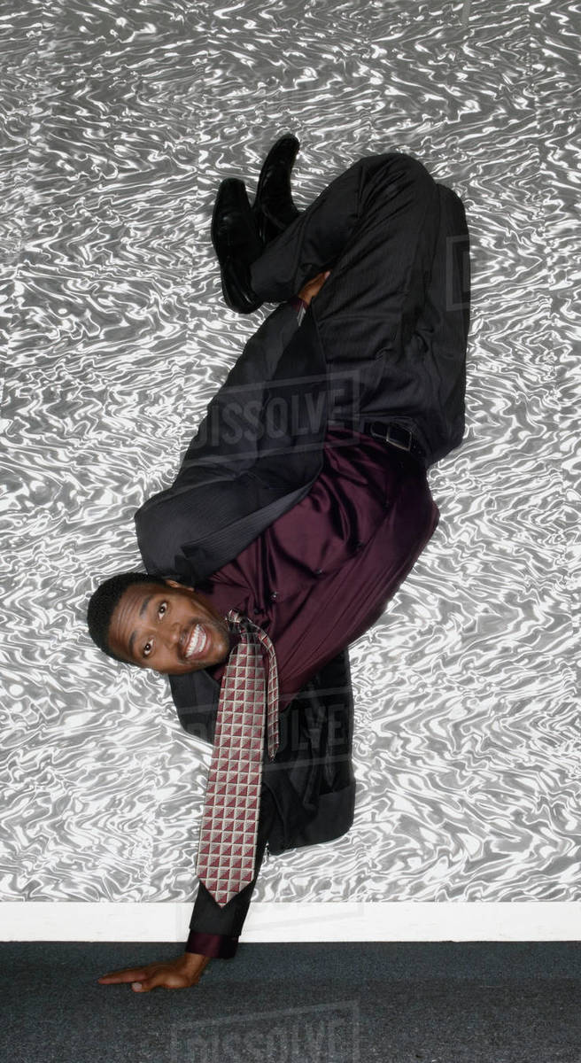 Portrait of African man performing handstand - Stock Photo - Dissolve