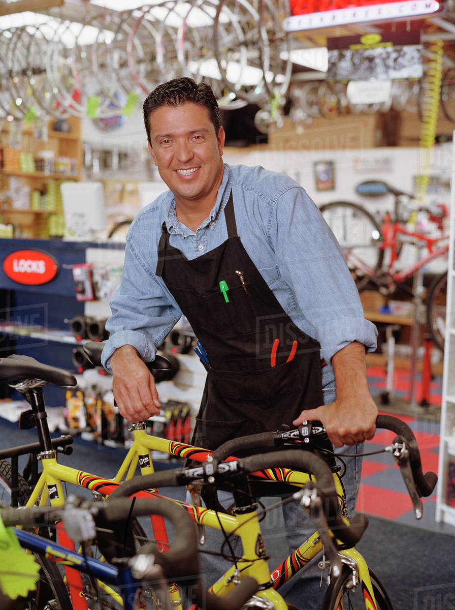 Bicycle salesman smiling for the camera - Royalty-free Stock Photo ...