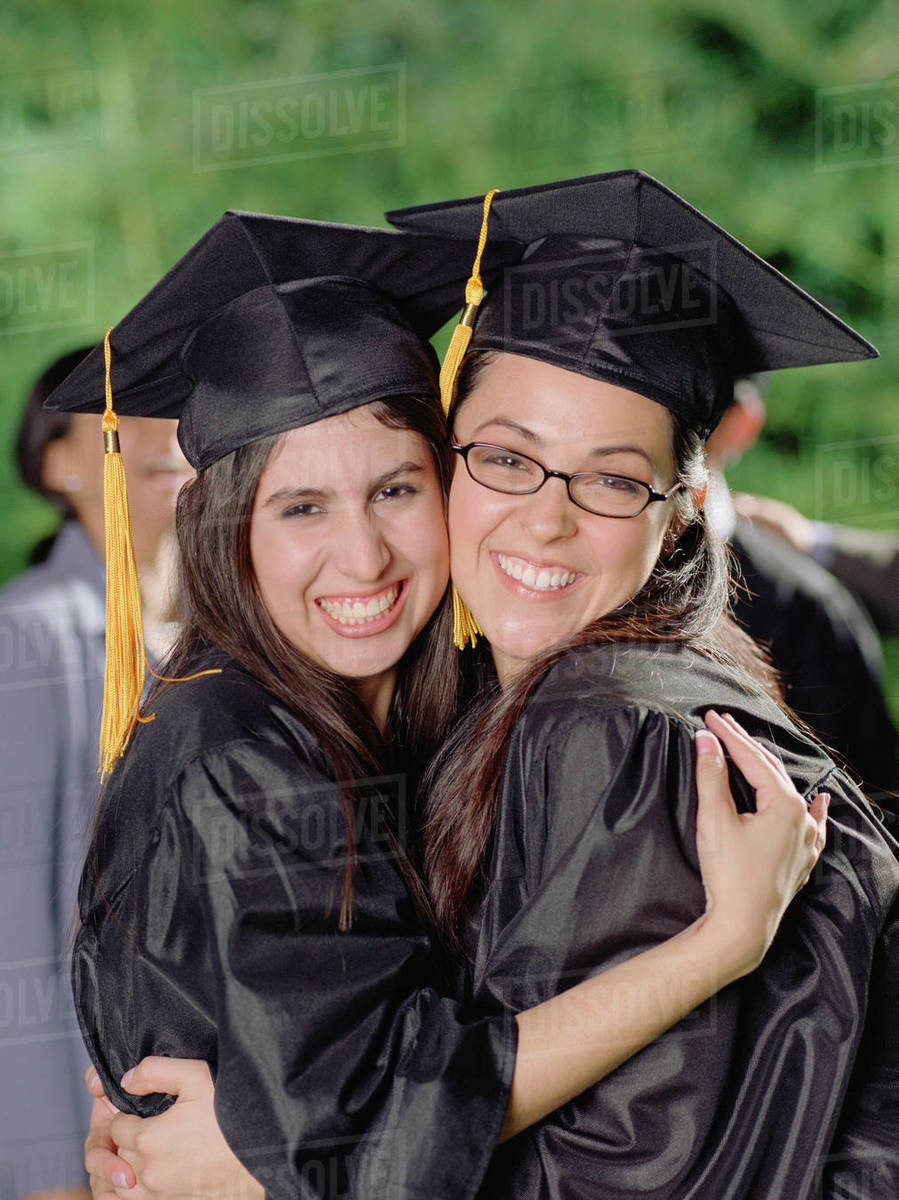 Female graduates hugging - Royalty-free Stock Photo | Dissolve