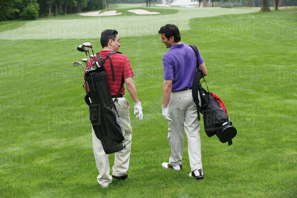 Rear view of two men playing golf - Royalty-free Stock Photo | Dissolve