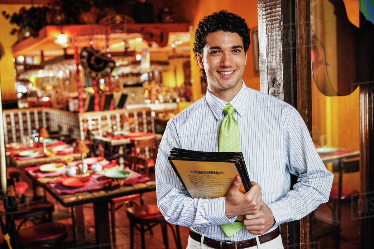 Portrait of waiter holding menus in restaurant - Royalty-free Stock ...