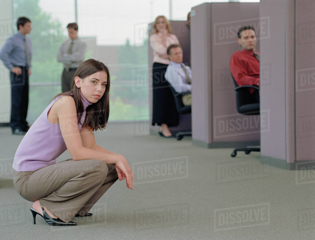 Businesswoman squatting on the floor of office - Royalty-free Stock ...