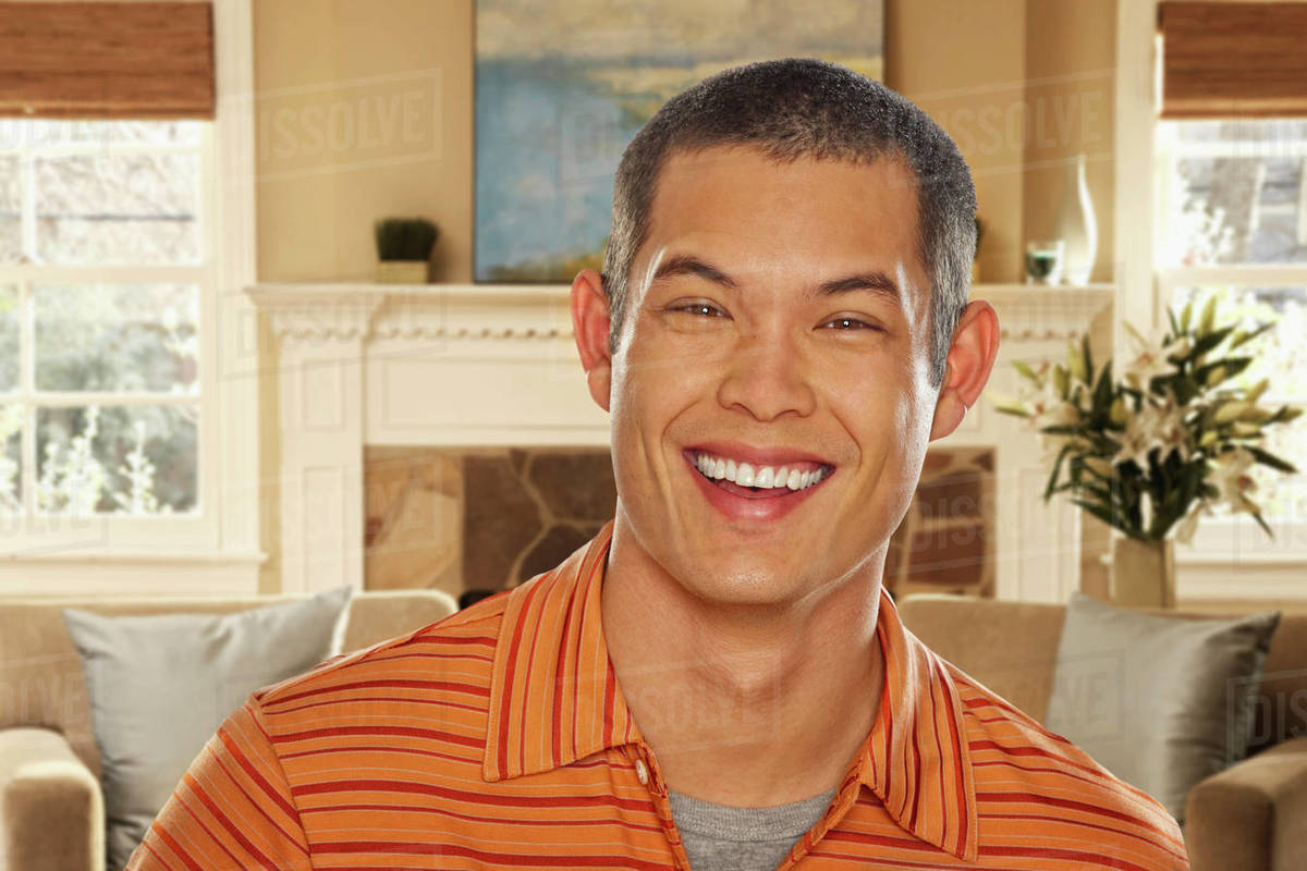 Smiling mixed race man in living room - Royalty-free Stock Photo | Dissolve