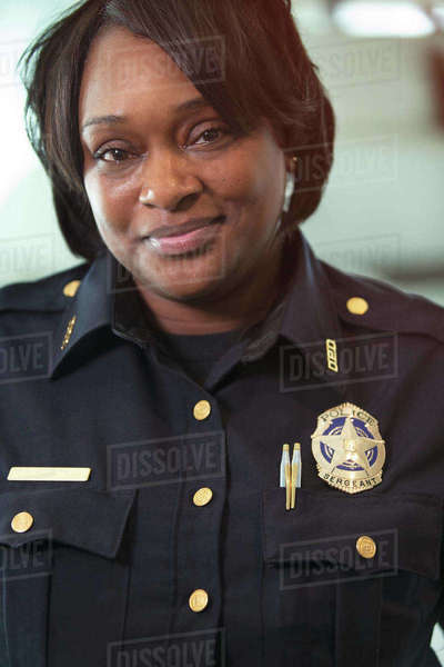 Portrait of Police woman Sergeant standing looking towards camera ...