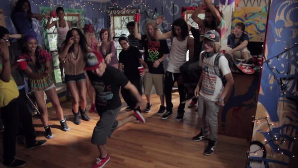 Group of friends at house party having a dance battle in a trashed ...
