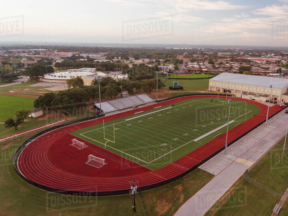 Aerial shot of a high school track and football field in Texas at ...