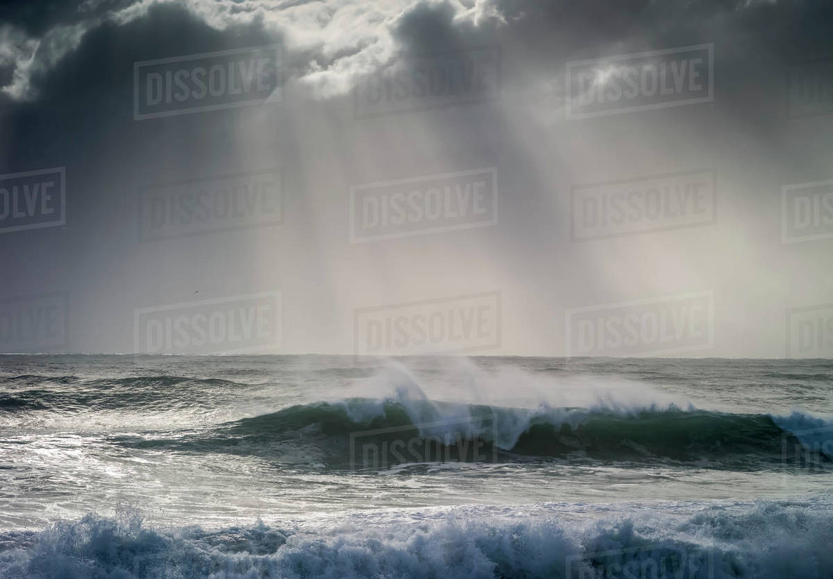 Huge wave curling over and breaking during cyclone Ola with stormy sky ...