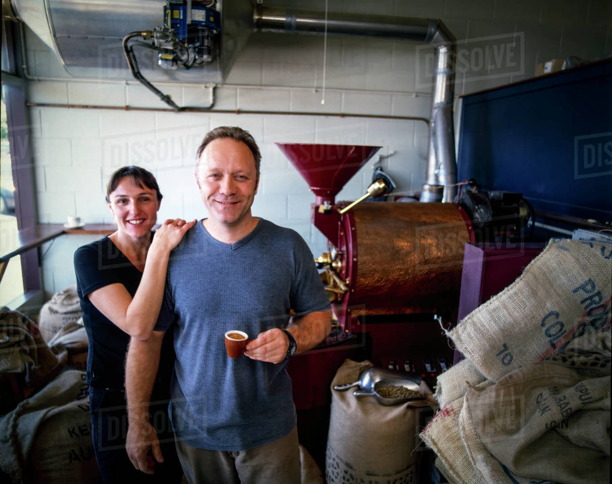 Portrait of coffee master roasters sampling cup of coffee in roasting ...