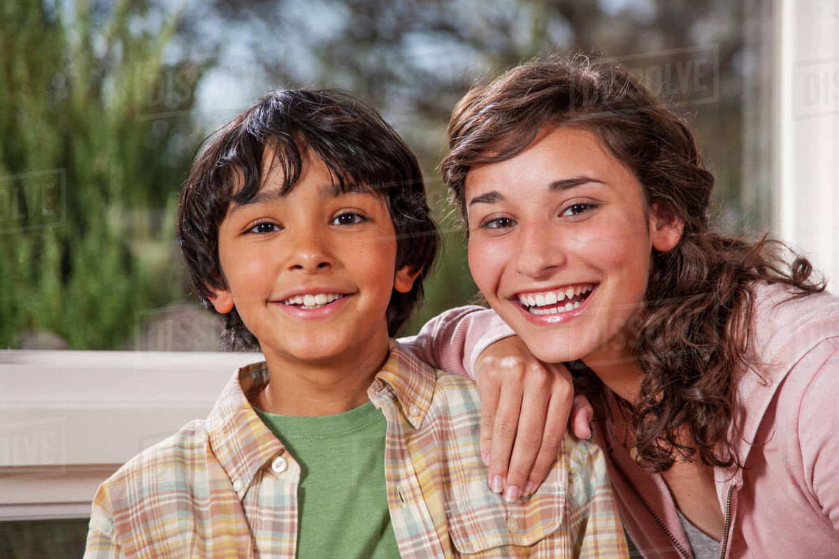 Smiling portrait of two siblings looking at camera smiling. - Royalty ...