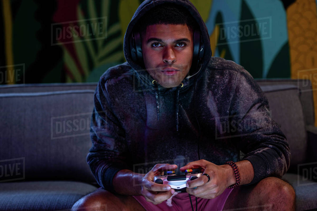 Young gamer man in hood playing game with game controller - Stock Photo ...