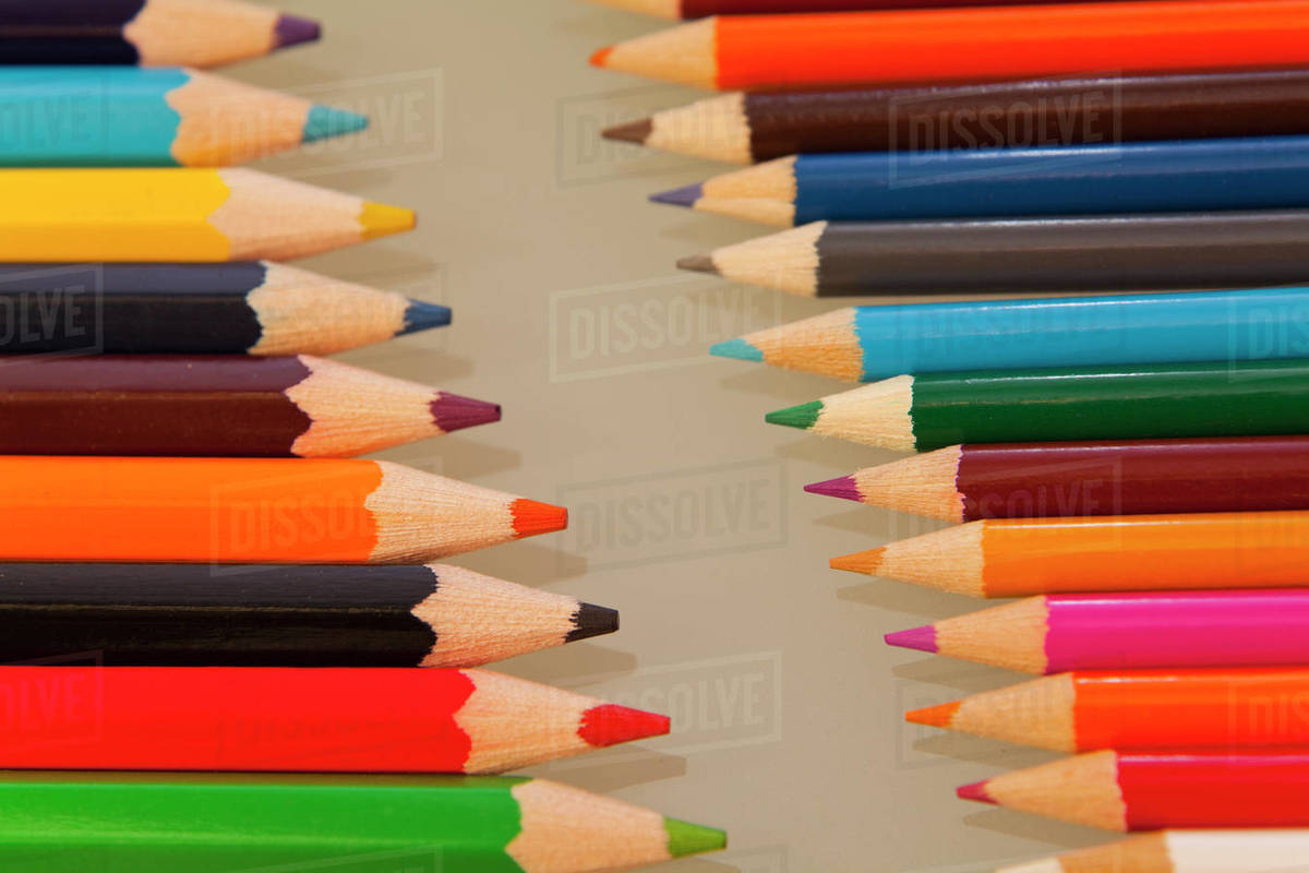 Row of colored pencils with sharp points - Stock Photo - Dissolve