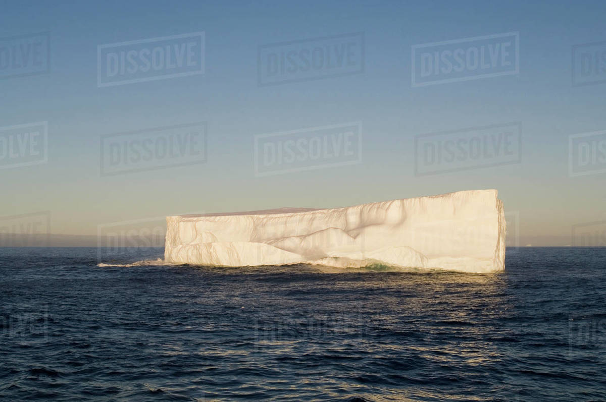 Iceberg floating on water - Stock Photo - Dissolve